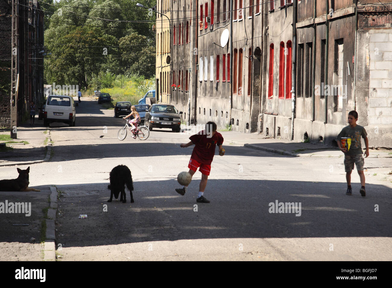 Kids playing football on the old street. Lipiny district ...
