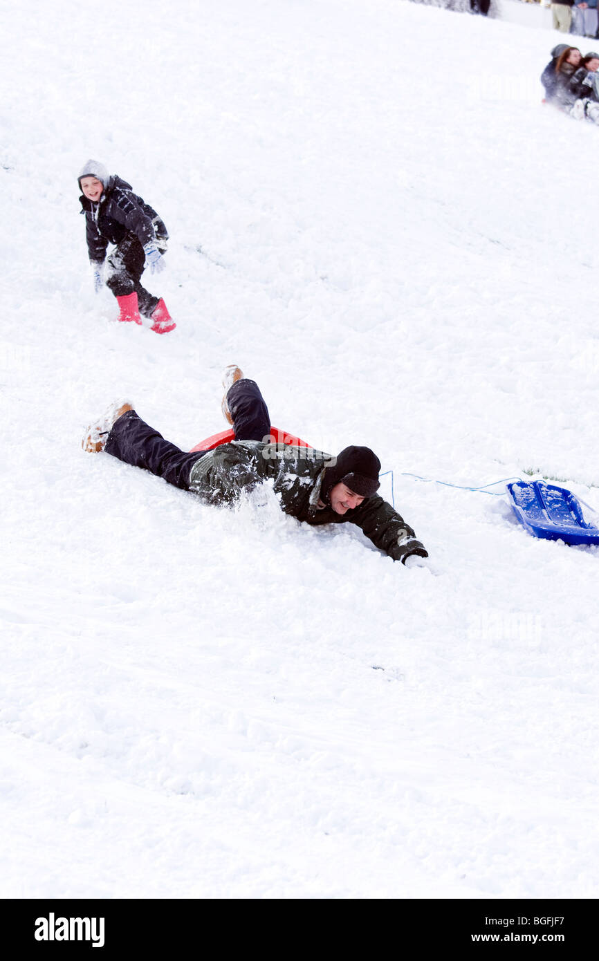 Man falling off sledge Stock Photo - Alamy