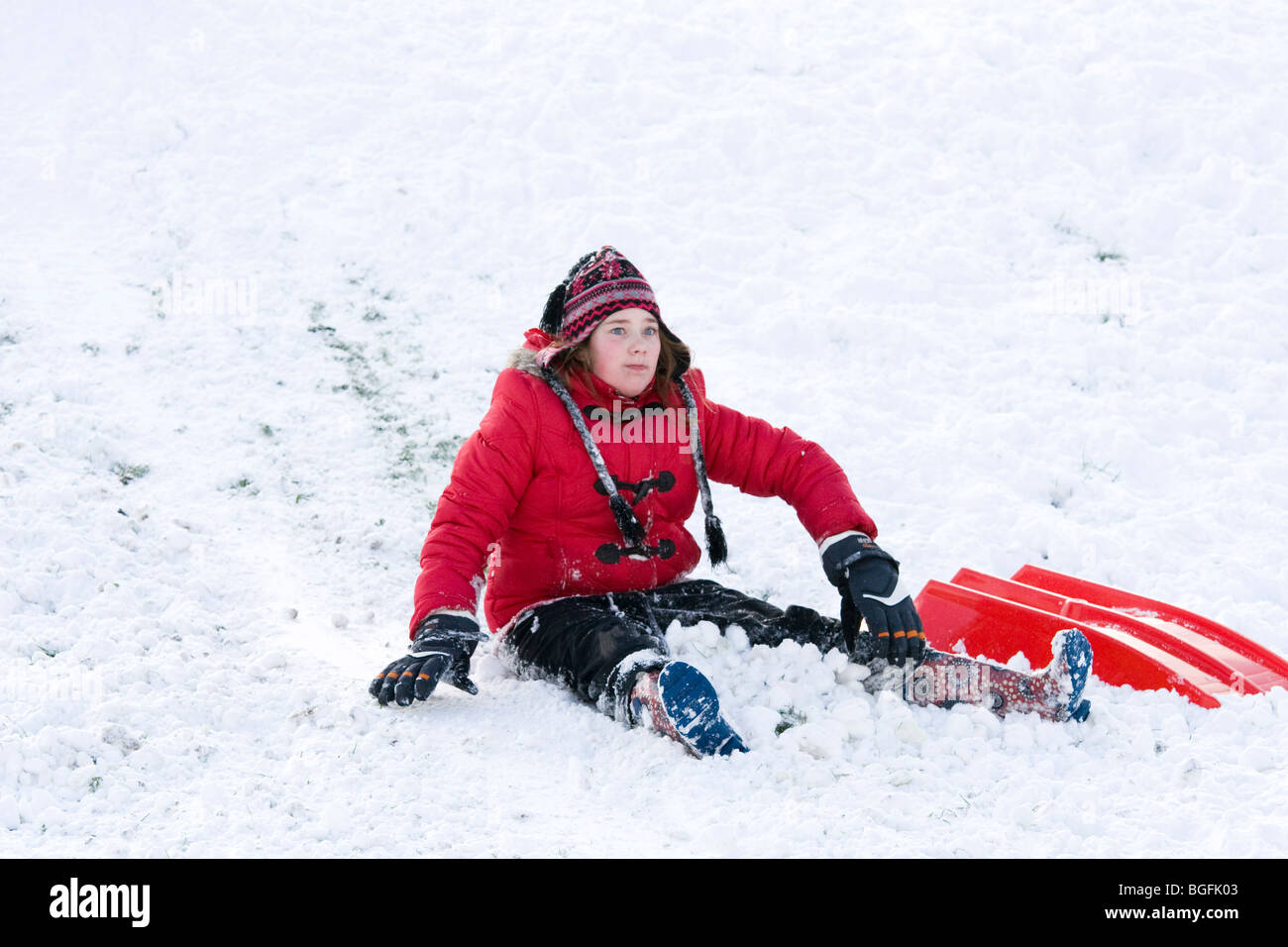 girl fallen off sledge Stock Photo - Alamy