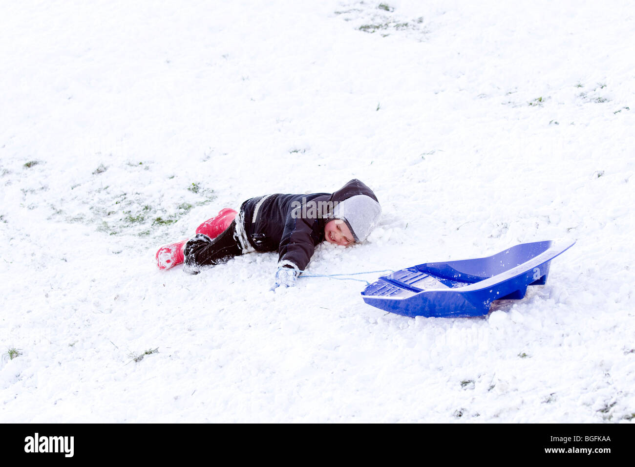 boy fallen from sledge Stock Photo - Alamy