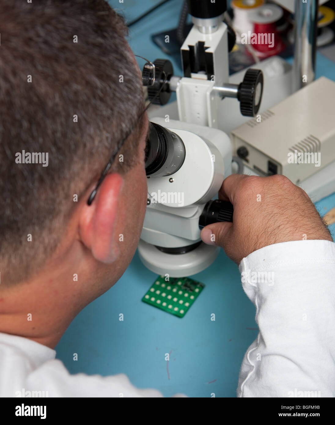 Male scientist using a microscope Stock Photo - Alamy