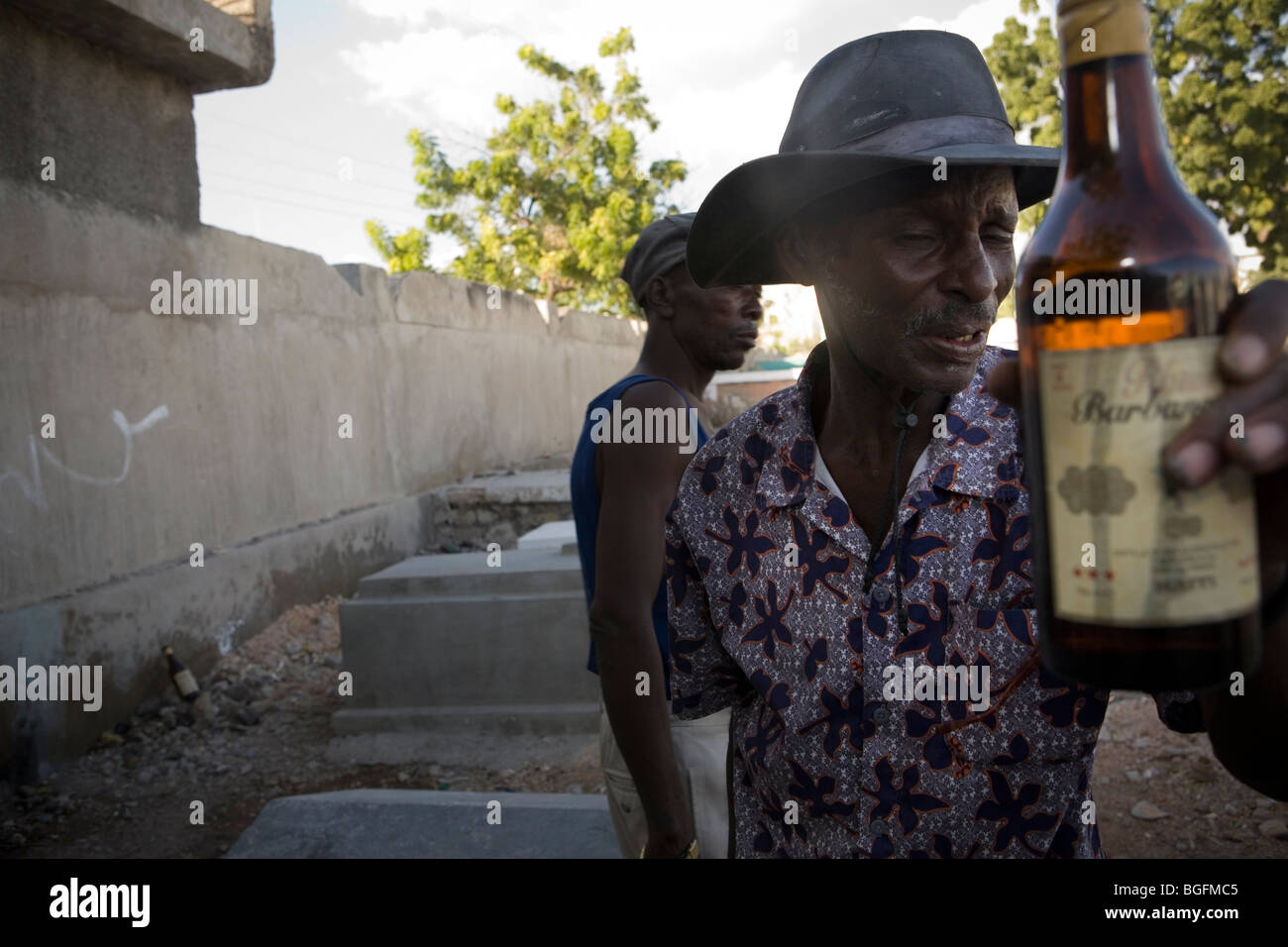 A voodou priest drinks rum in a cemetery in Gonaives, Artibonite ...