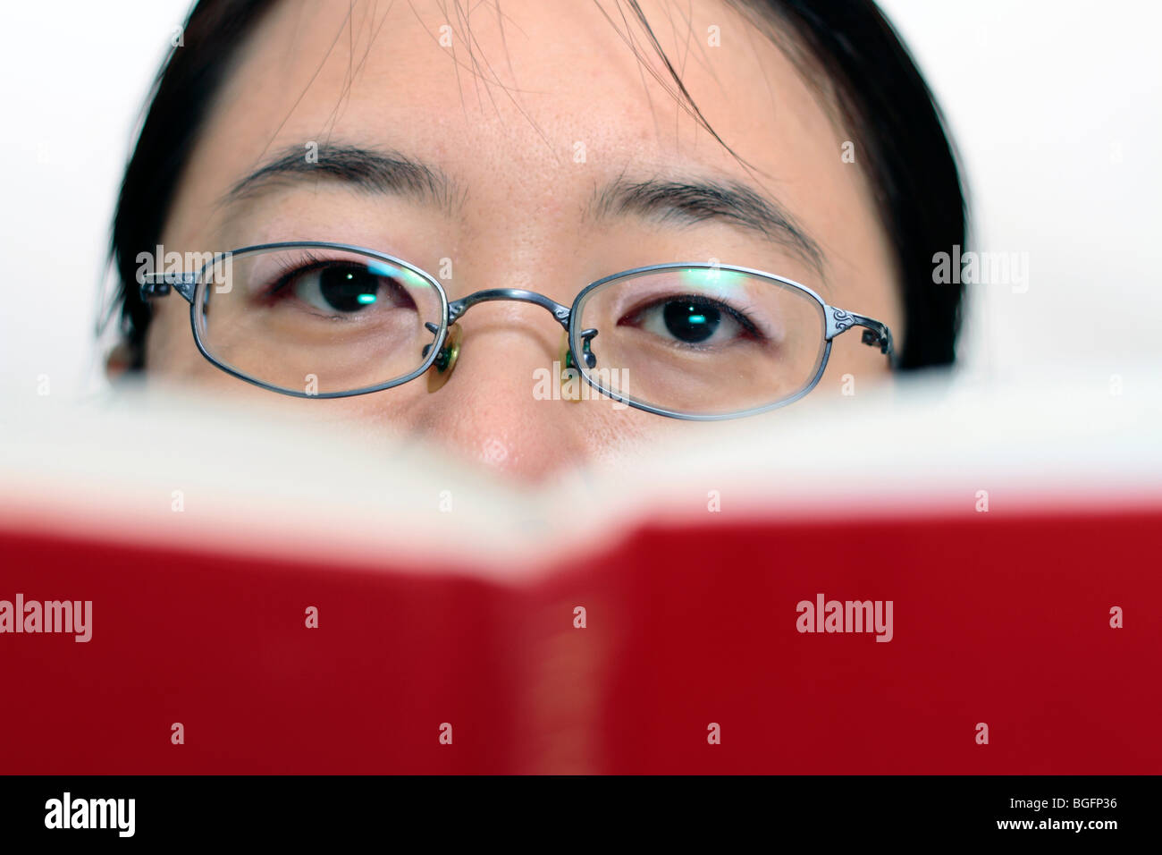 An Asian woman reading a book Stock Photo - Alamy