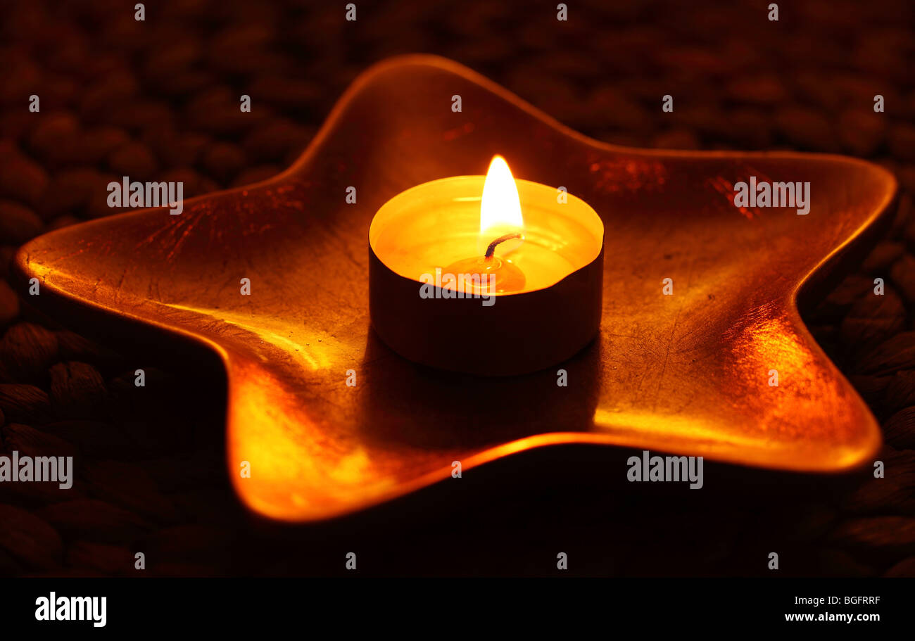 Burning candle in star hi-res stock photography and images - Alamy