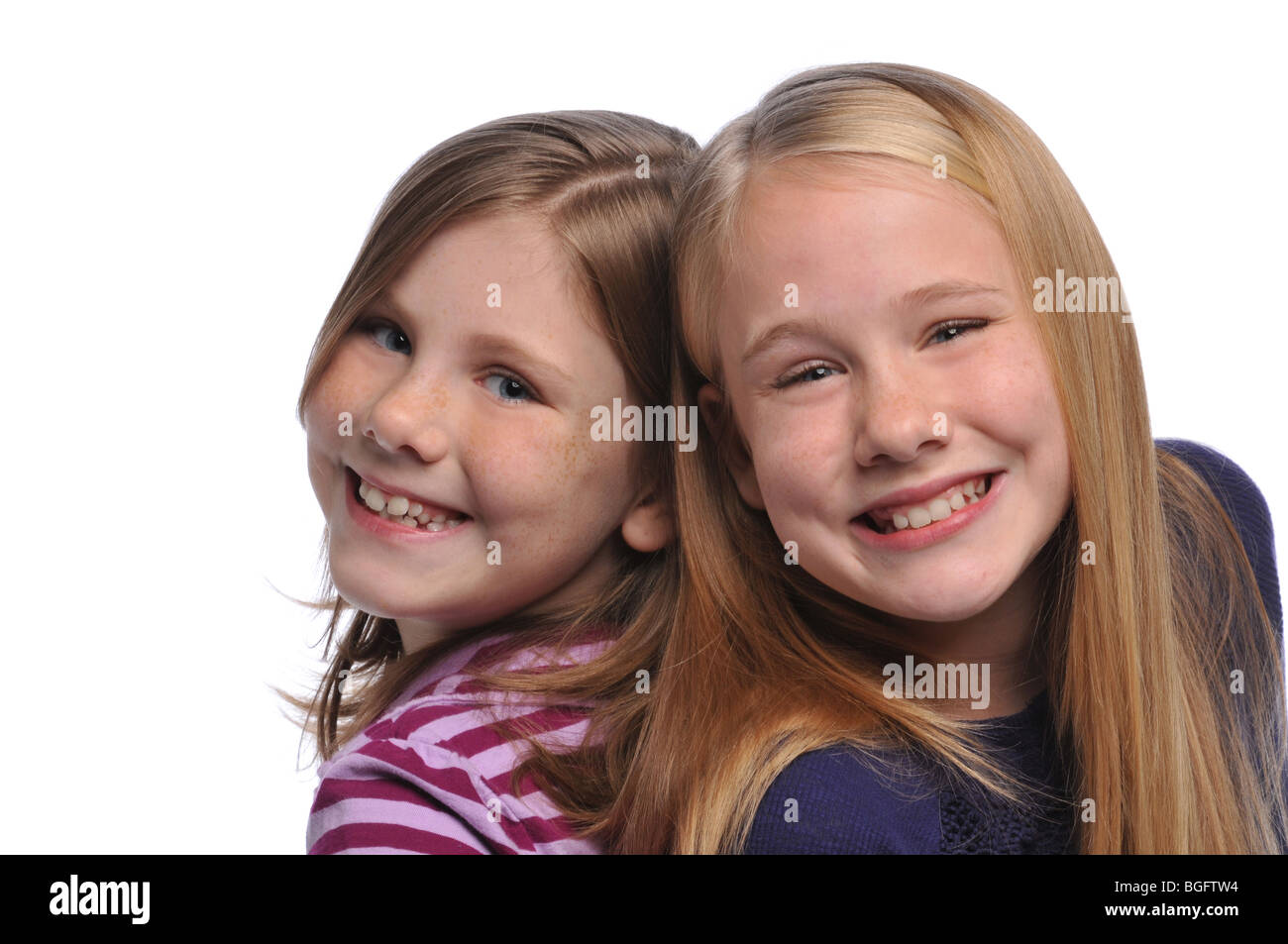 Two sisters smiling isolated on a white background Stock Photo - Alamy