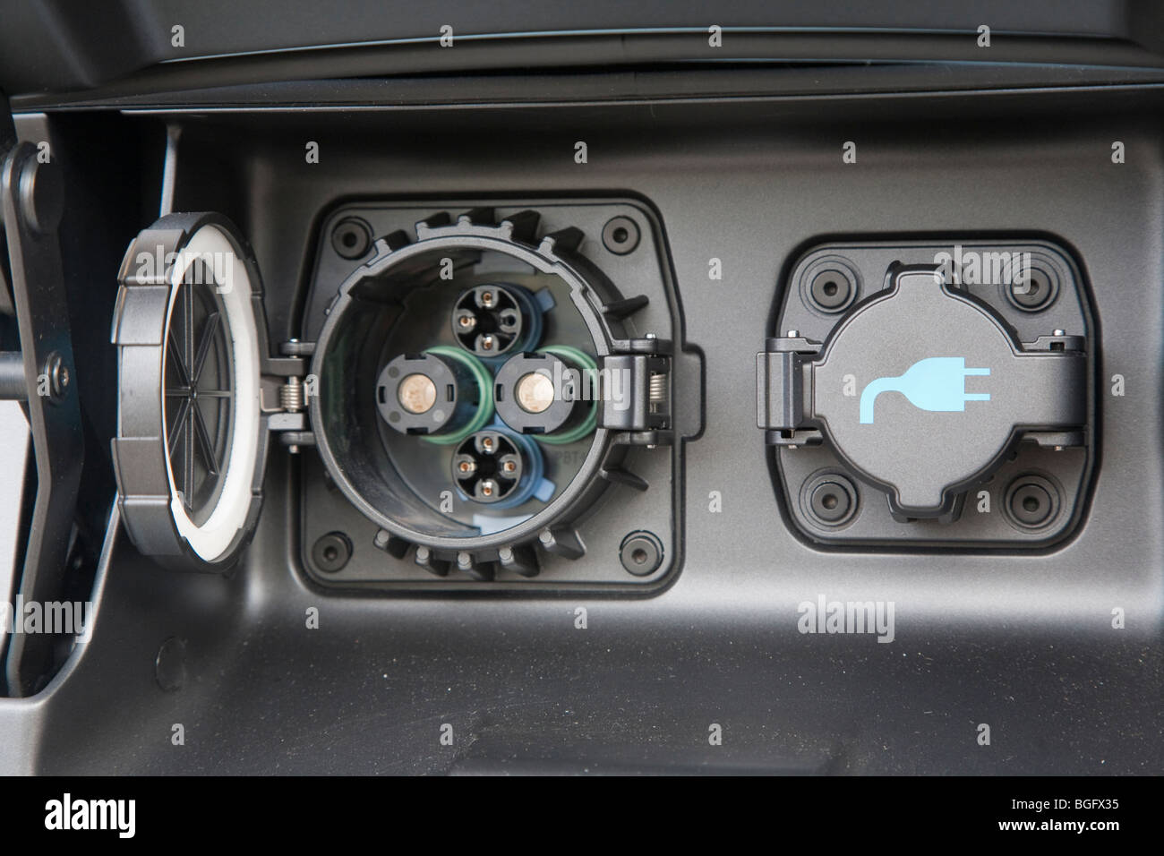 Close up of electric charging plugs compartment, in lieu of a gas tank ...