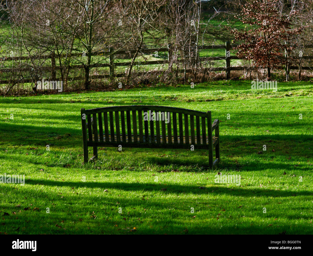 a bench on a hill in a country garden Stock Photo - Alamy