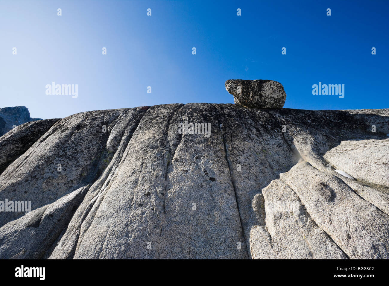 A rock sitting atop a grooved cliff wall, Enchantment Lakes Wilderness ...