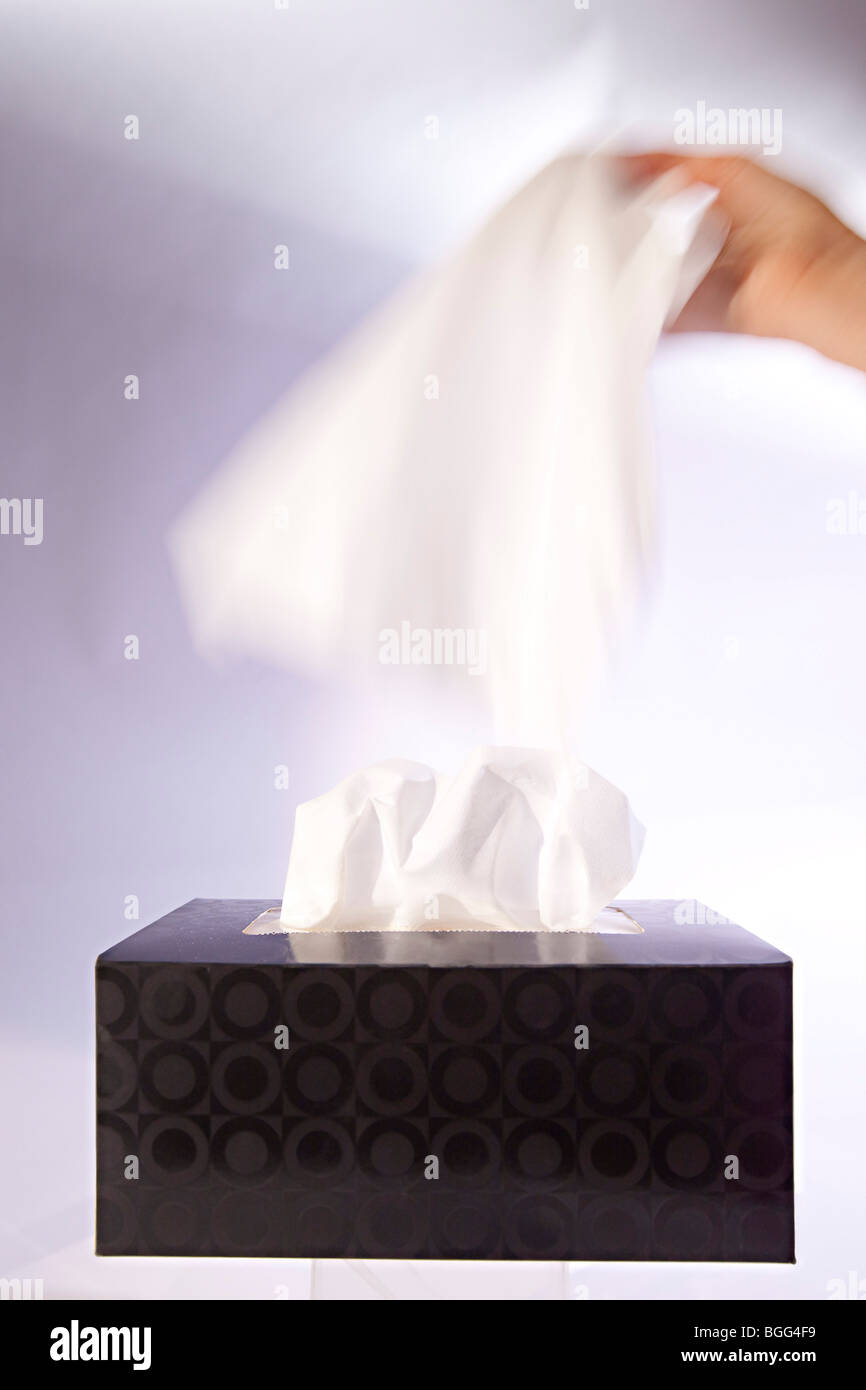 Hand taking a tissue from a tissue box Stock Photo - Alamy