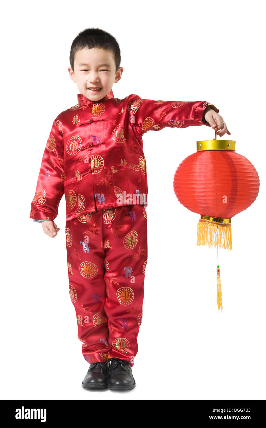 Boy in Chinese traditional clothes holding red lantern Stock Photo - Alamy