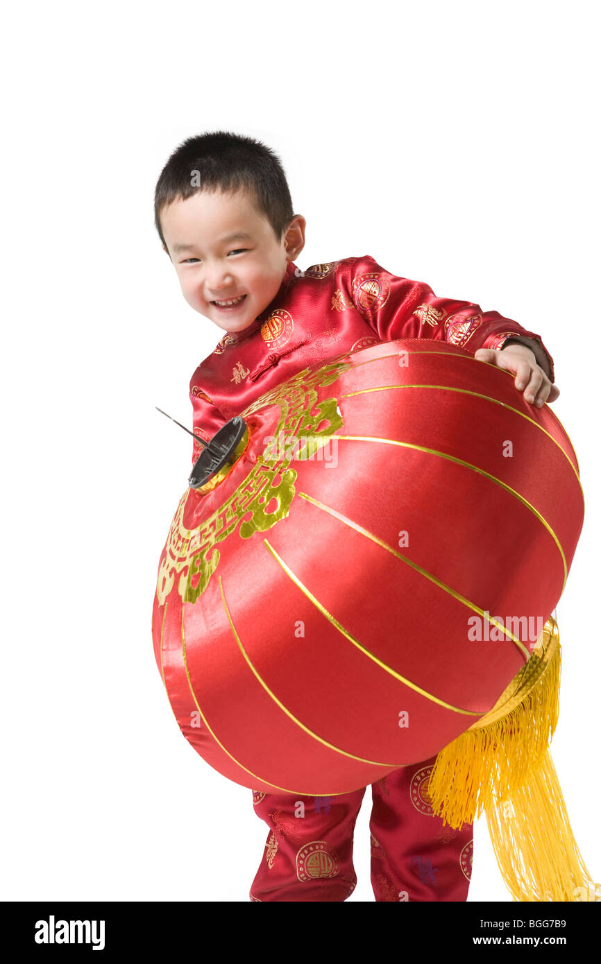 Boy in Chinese traditional clothes holding red lantern Stock Photo - Alamy