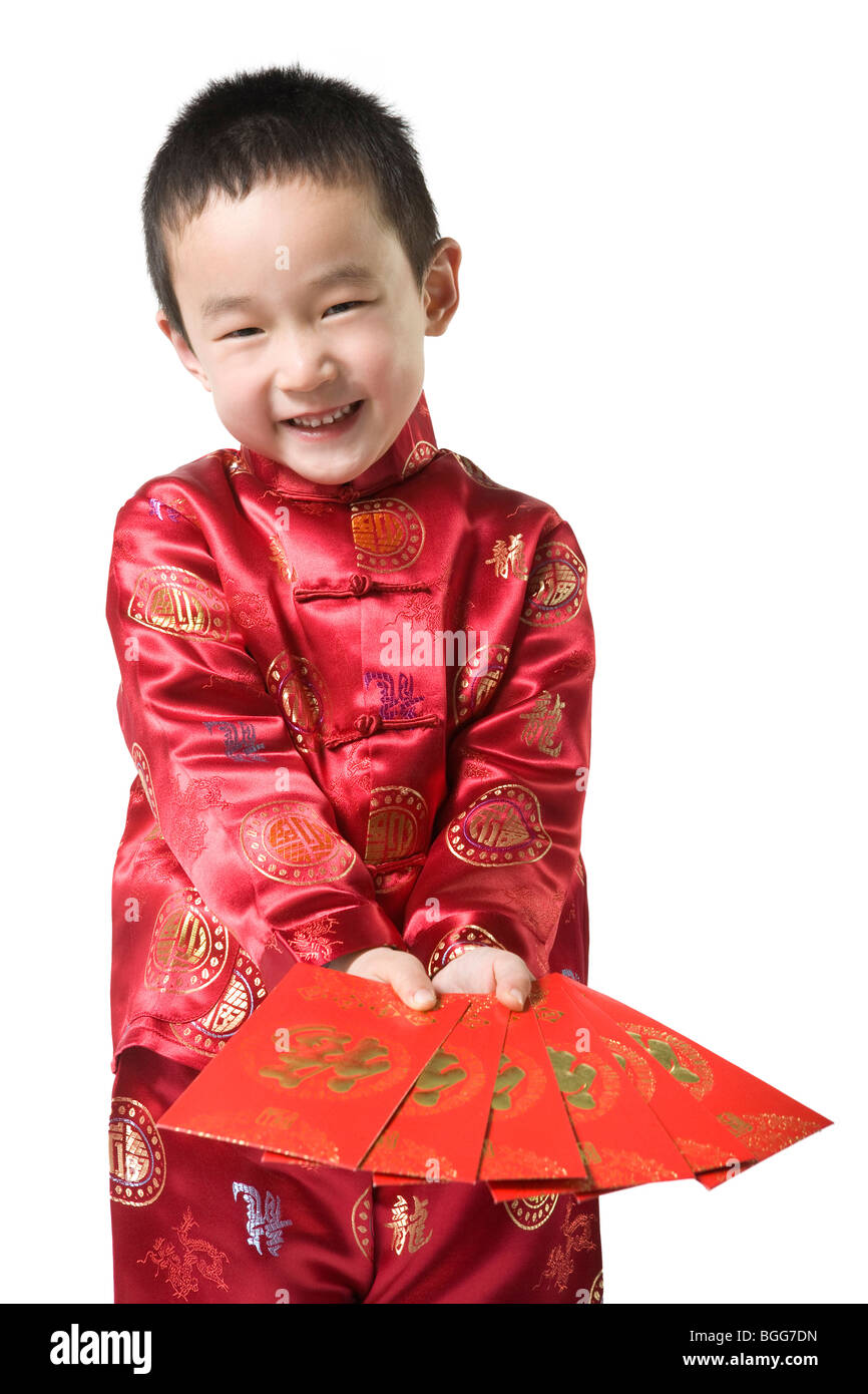 Boy in Chinese traditional clothes holding red envelop Stock Photo - Alamy