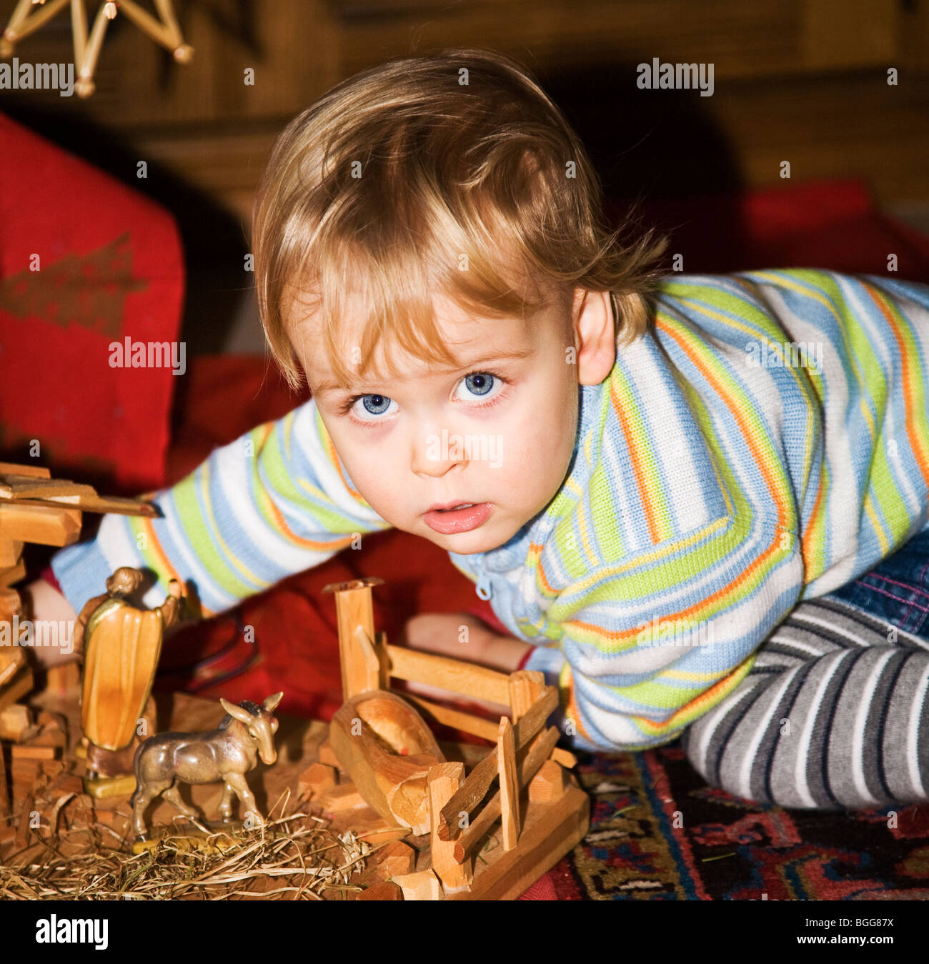 Child playing with a nativity set hi-res stock photography and images ...