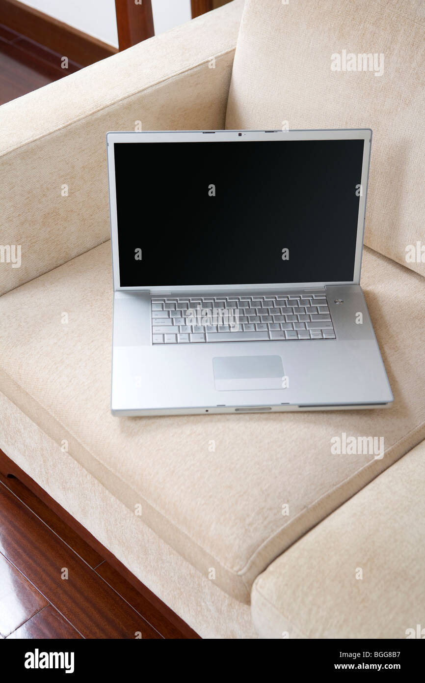 Macbook Laptop on Sofa Stock Photo - Alamy