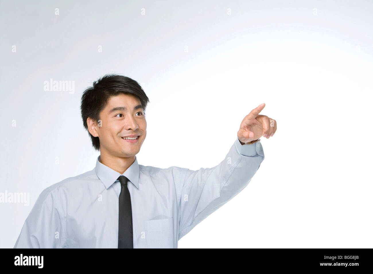 Young Businessman pointing the front by finger Stock Photo - Alamy