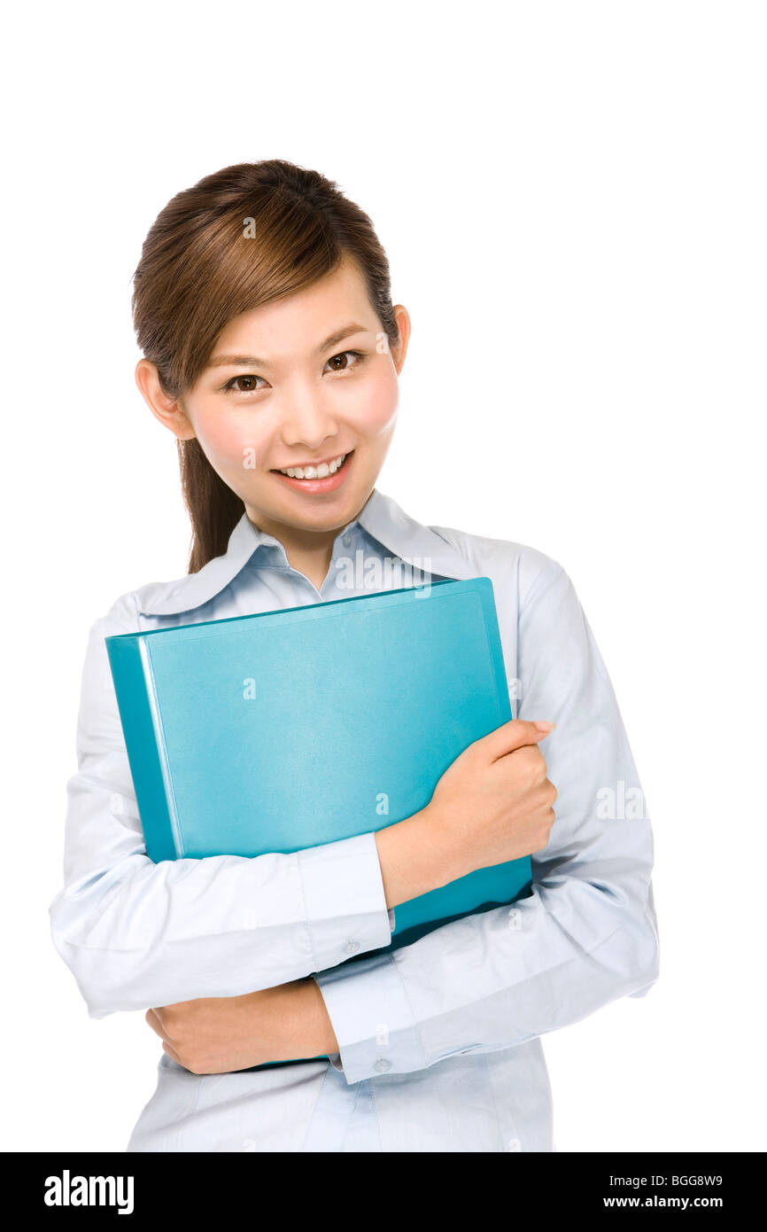 Smiling young businesswoman holding file folder Stock Photo - Alamy