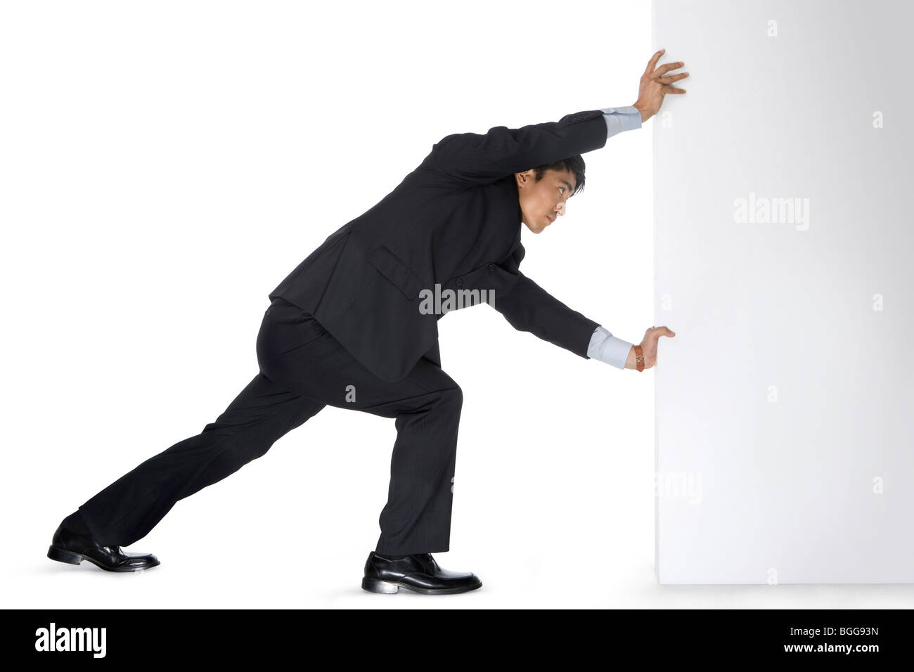 Young businessman pushing a white board Stock Photo - Alamy