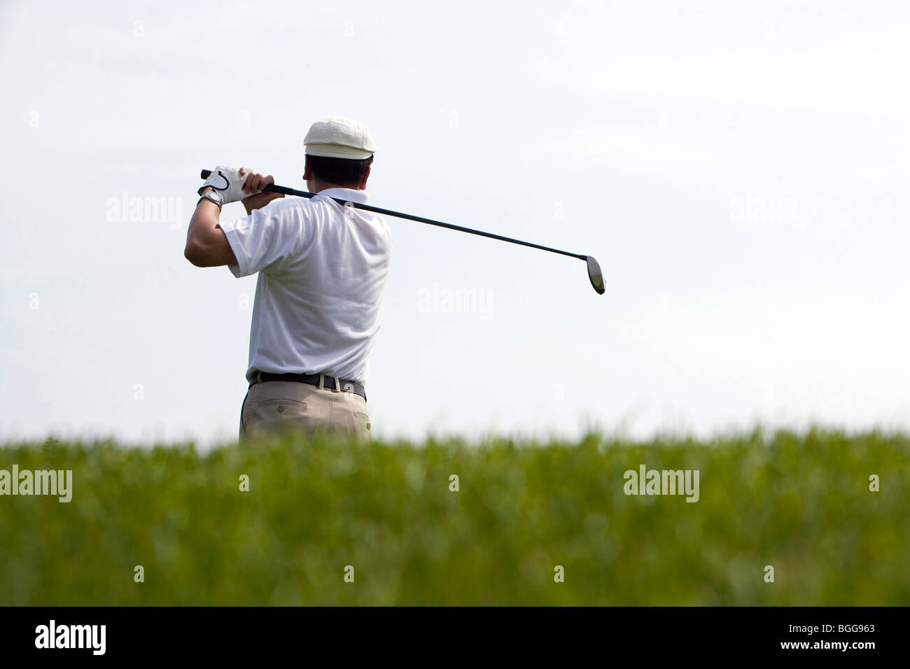Rear View of Golfer's Swing Stock Photo - Alamy