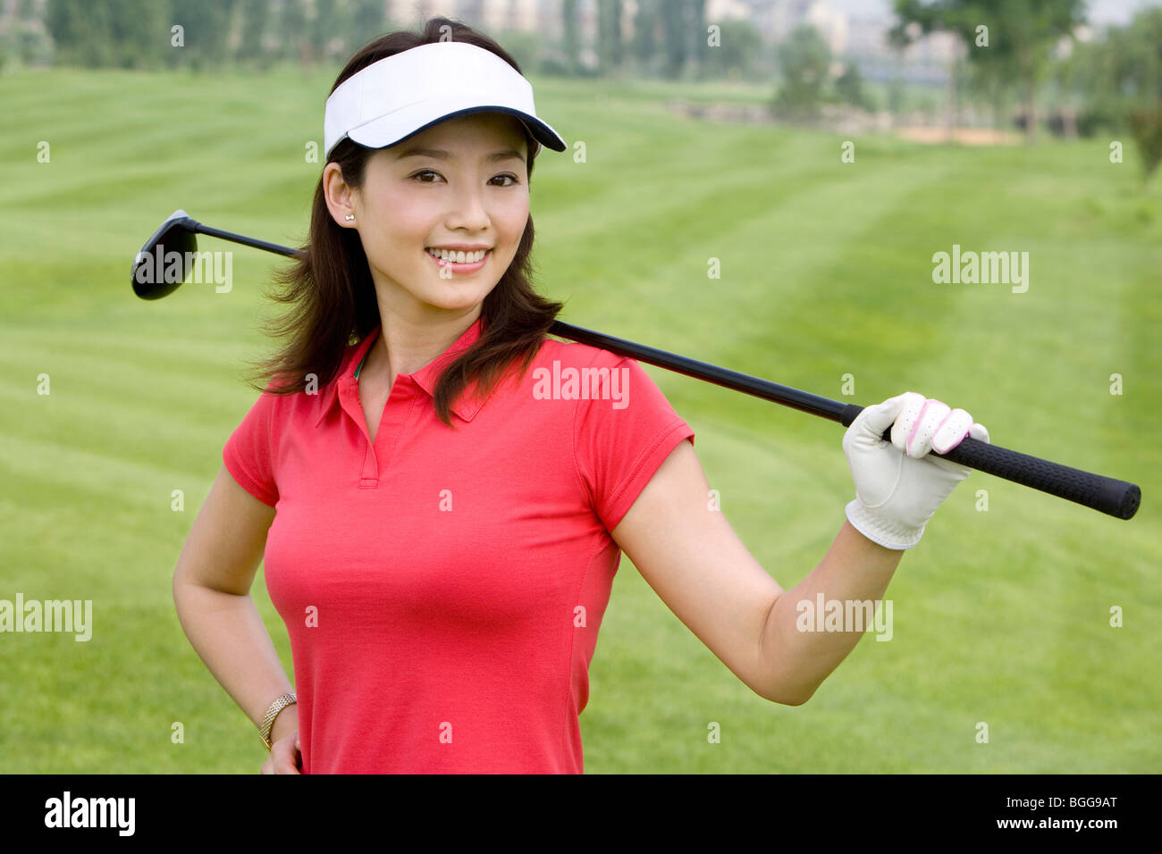 Portrait of a female golfer on the course Stock Photo - Alamy