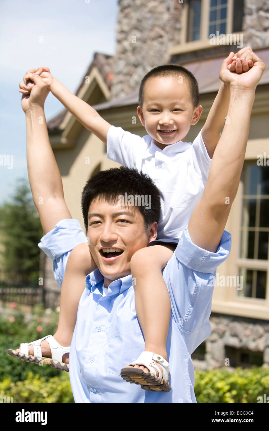 Father carrying son on shoulder Stock Photo - Alamy