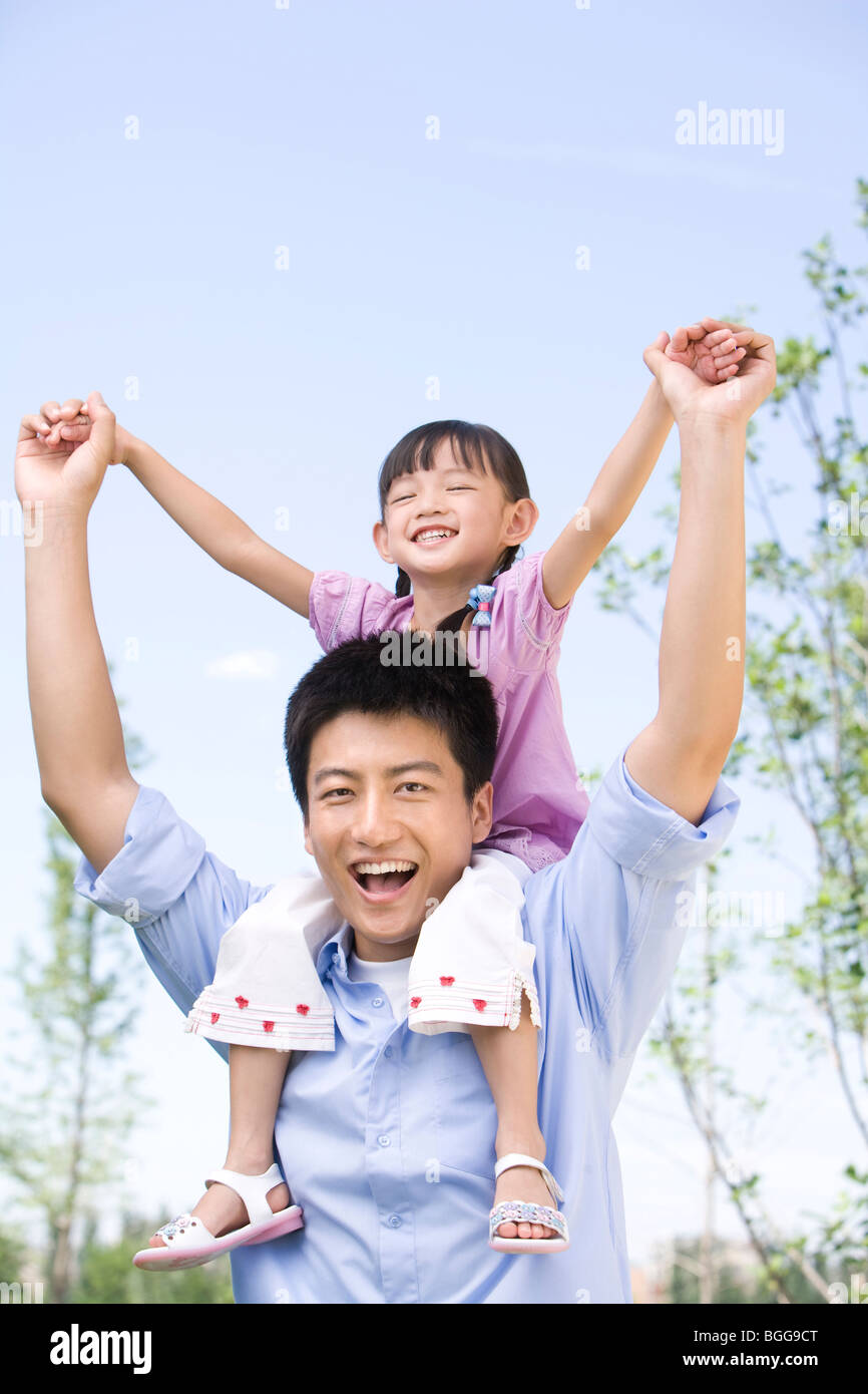 Father carrying daughter on shoulder Stock Photo - Alamy