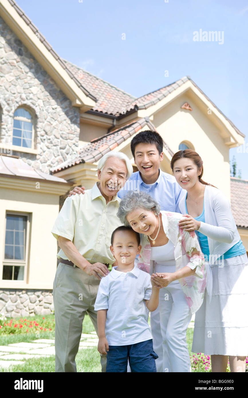 Three generation family in front of house Stock Photo - Alamy