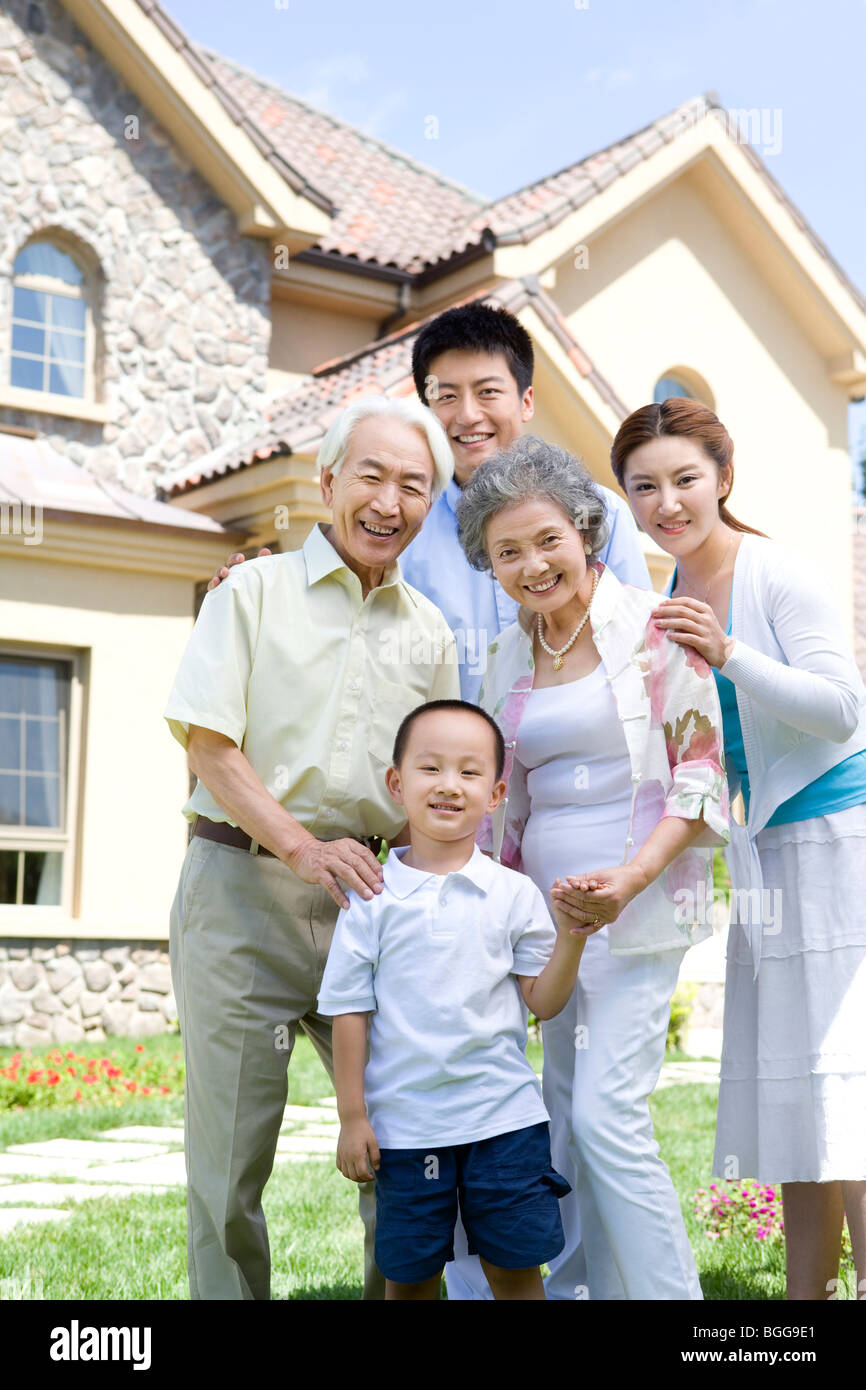Three generation family in front of house Stock Photo - Alamy