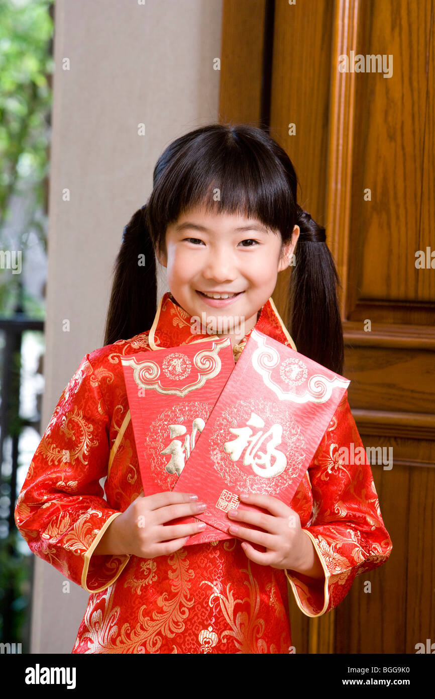 Portrait of a girl holding Chinese red envelope Stock Photo - Alamy