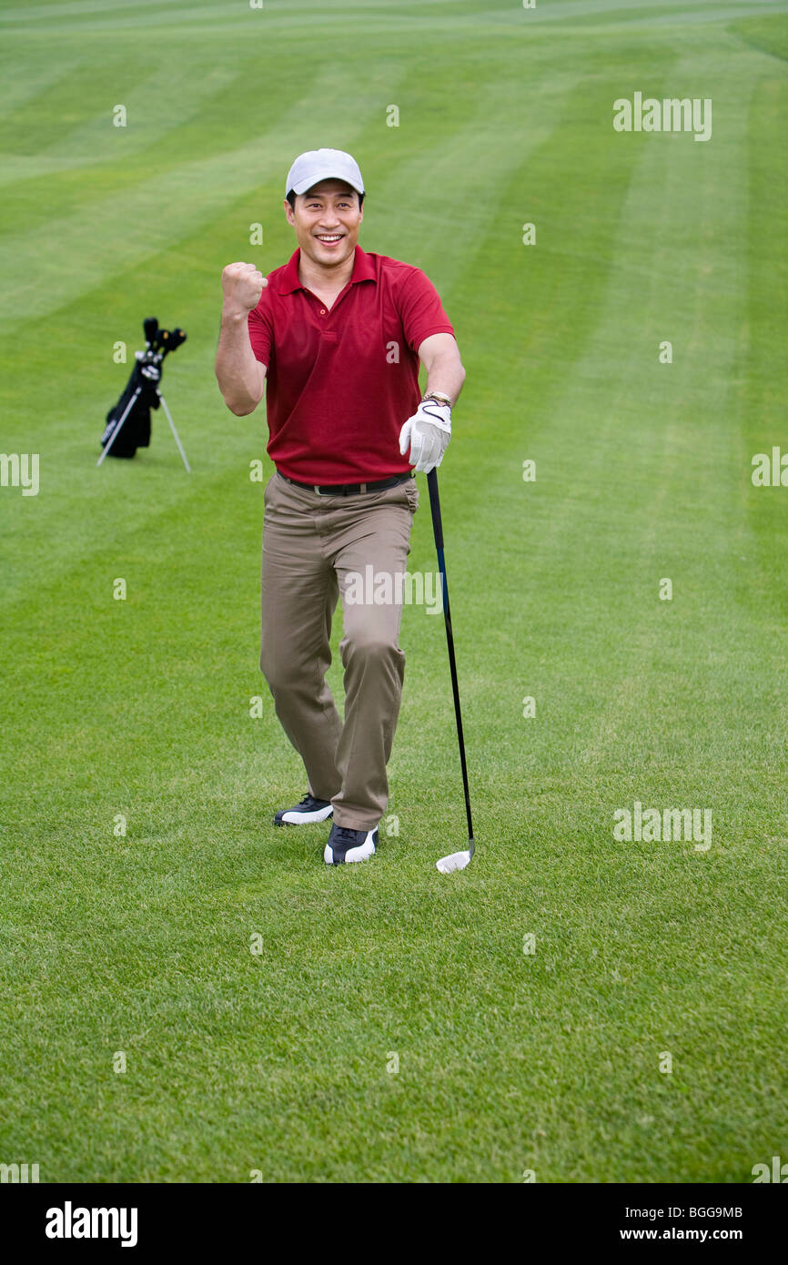 Male golfer celebrating a nice shot on the course Stock Photo - Alamy