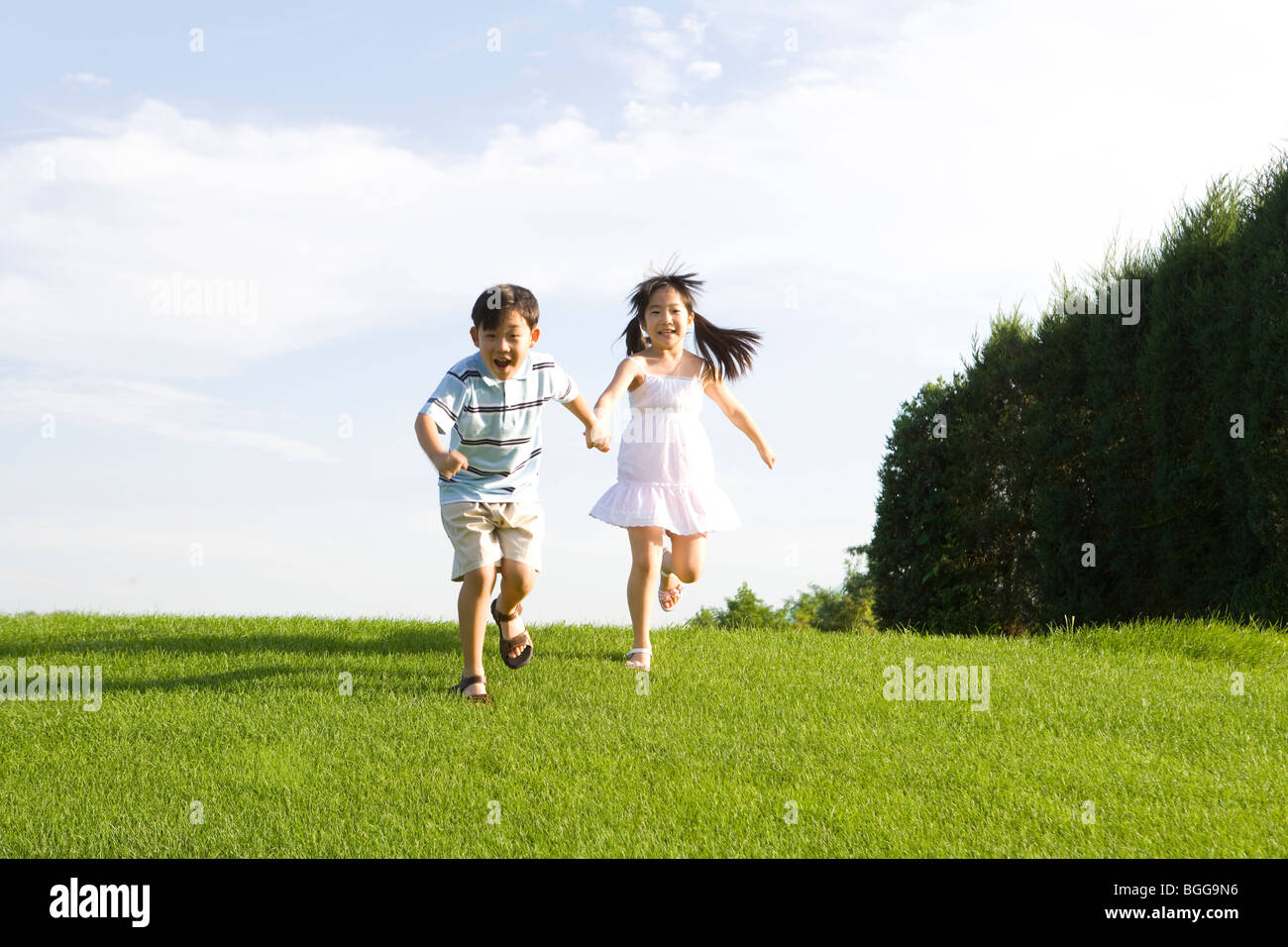 Children holding hands and running outdoors Stock Photo - Alamy