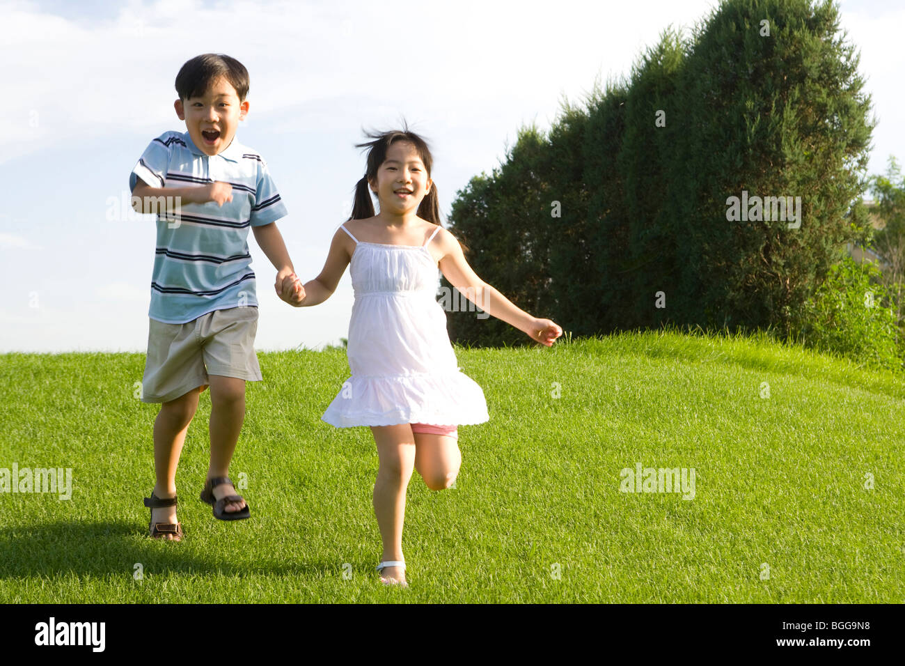 Children holding hands and running outdoors Stock Photo - Alamy