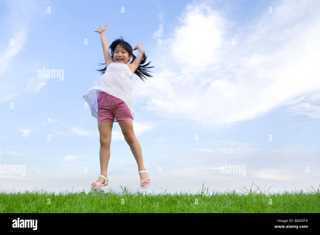 Girl jumping in mid-air Stock Photo - Alamy