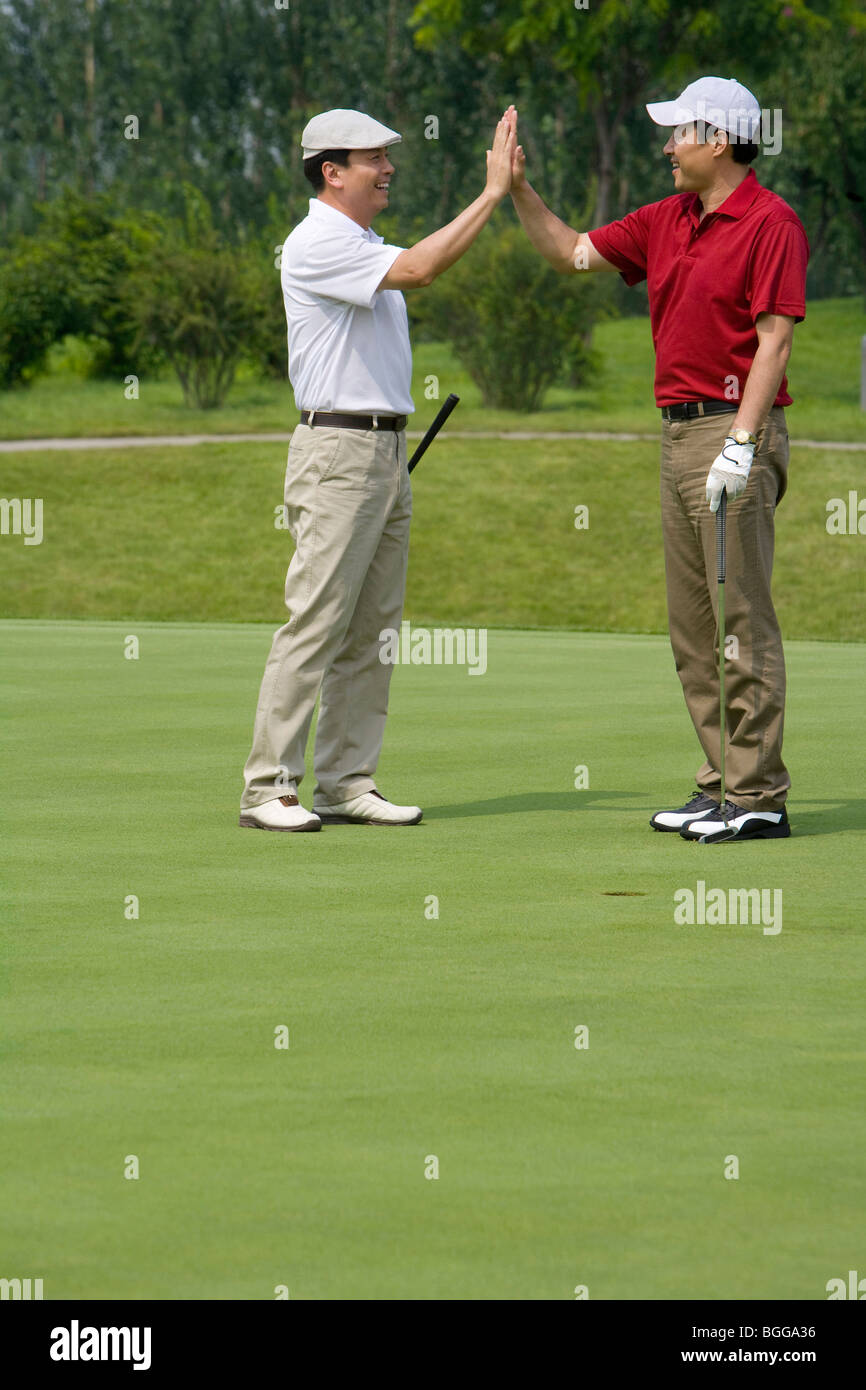 Golfers high five hi-res stock photography and images - Alamy