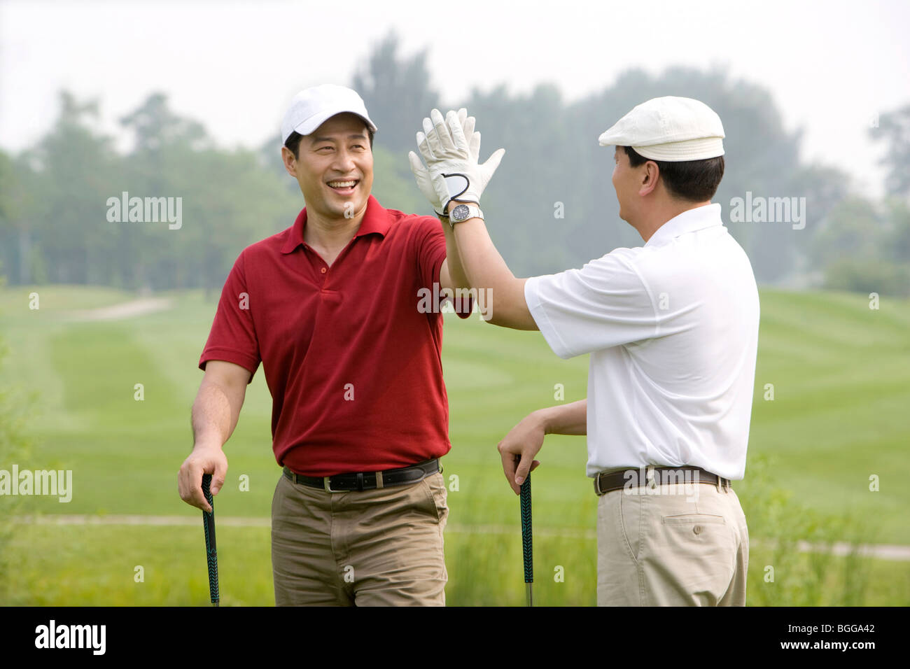 Two Golfers Celebrate a Great Shot Stock Photo - Alamy