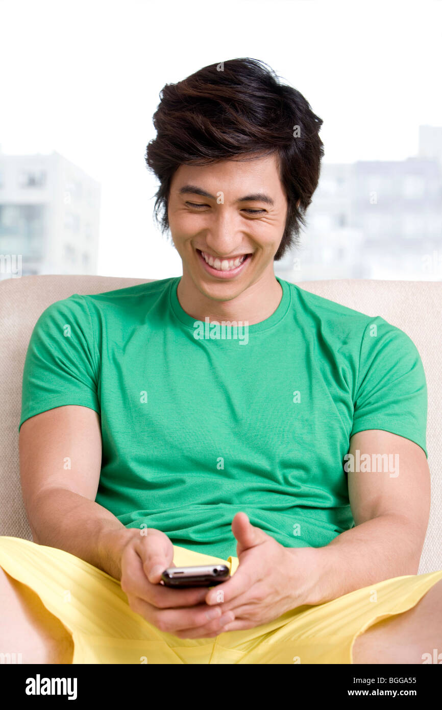 Man playing with his cellphone Stock Photo - Alamy