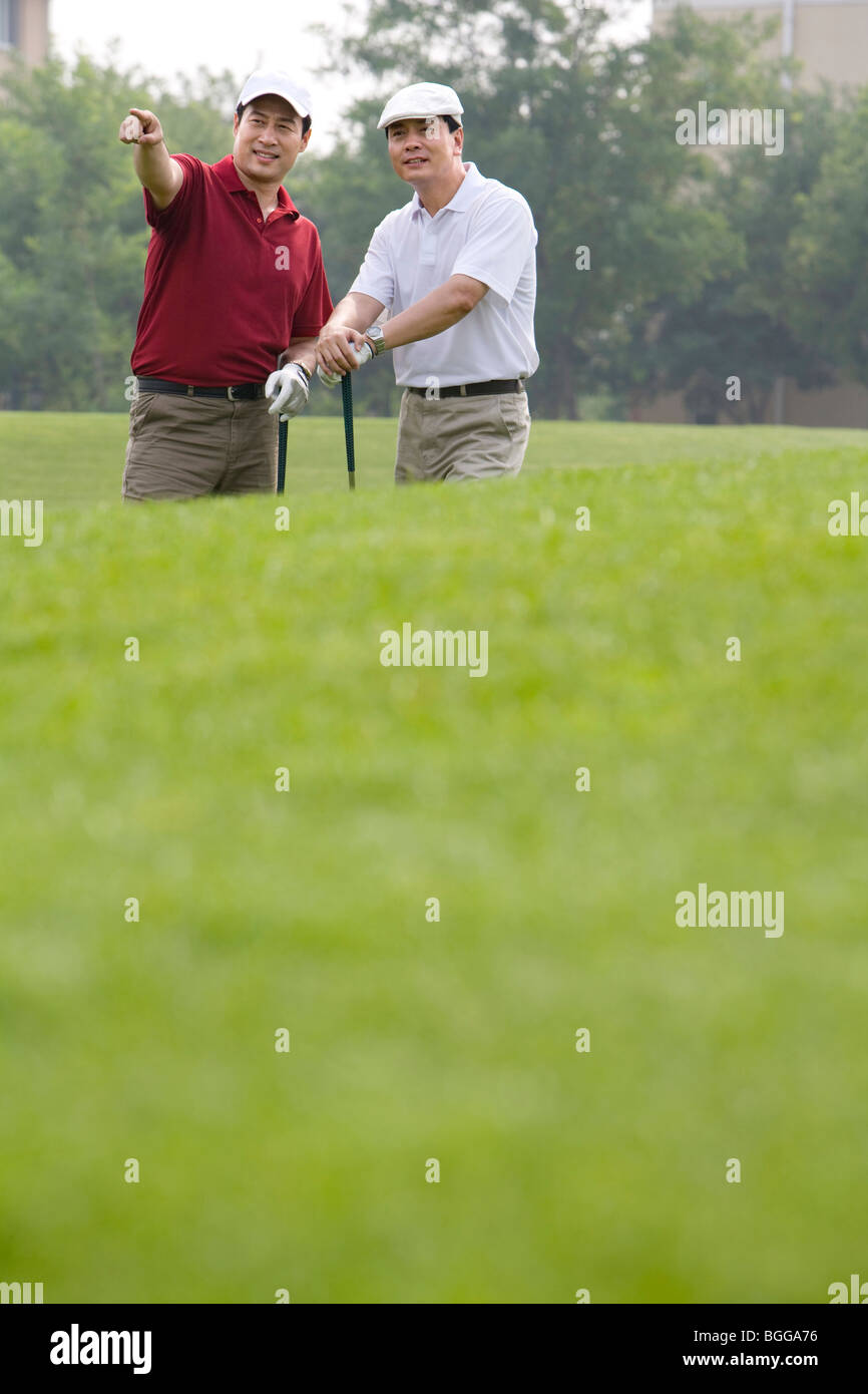 Two golfers chatting on the course Stock Photo - Alamy