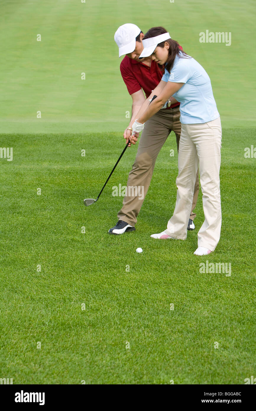 Golf coach teaching playing golf Stock Photo - Alamy