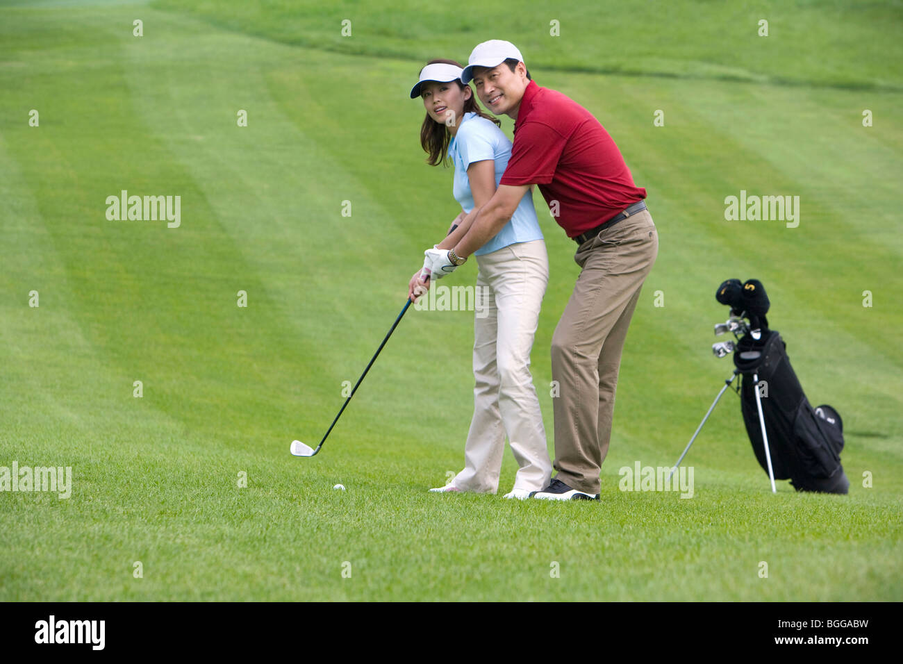 Golf coach teaching playing golf Stock Photo - Alamy