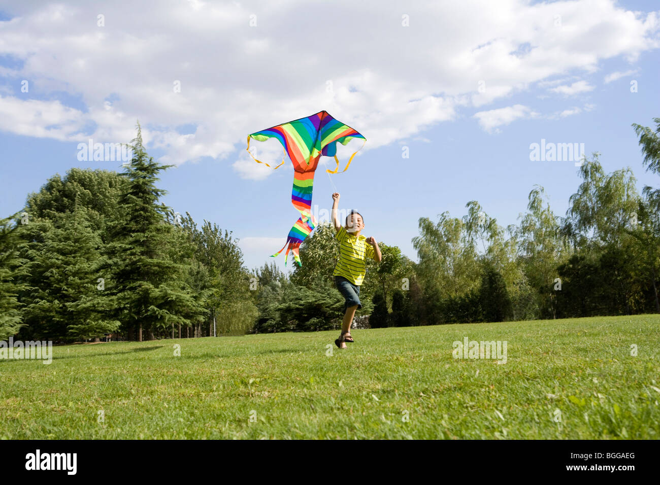 Young boy running with kite outdoors Stock Photo - Alamy