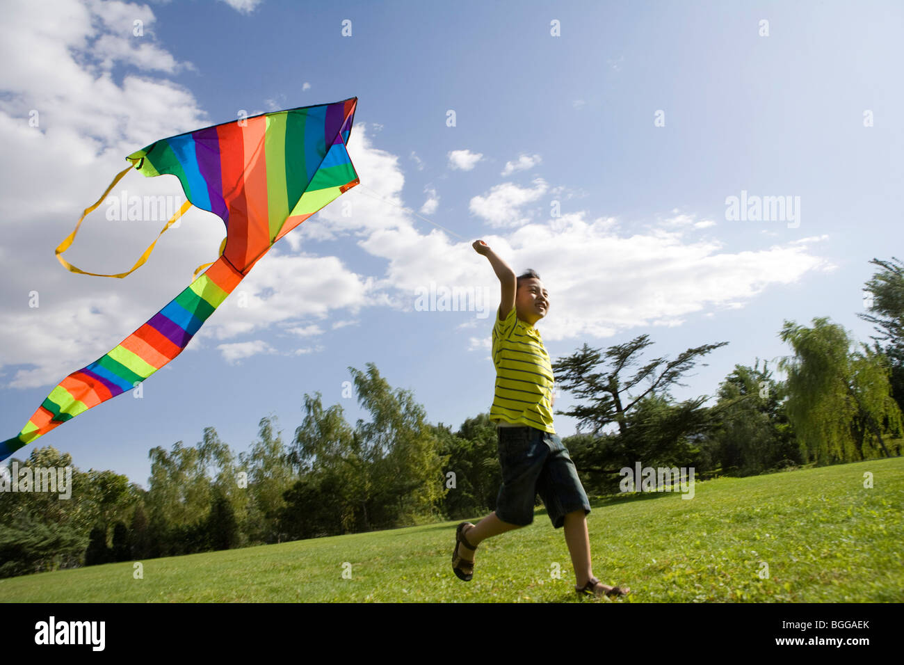 Young boy running with kite outdoors Stock Photo - Alamy