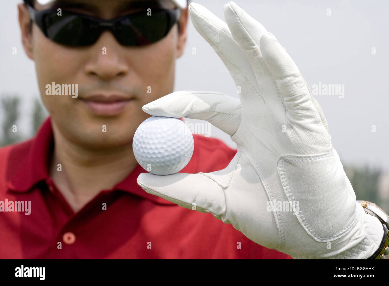 Close-up of a golf ball in golfer's hand Stock Photo - Alamy