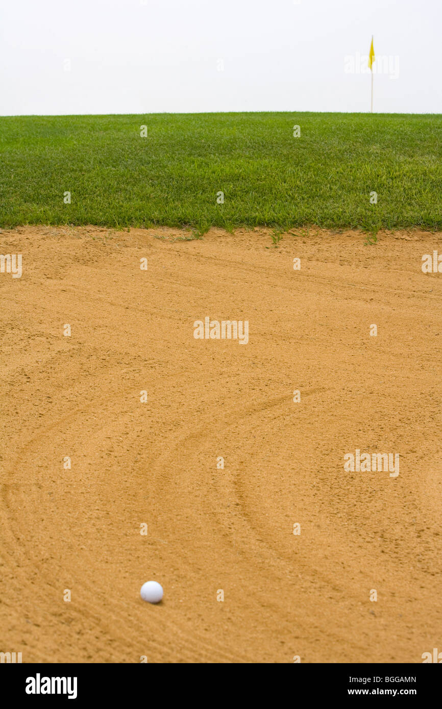 Golf ball in sand bunker Stock Photo - Alamy