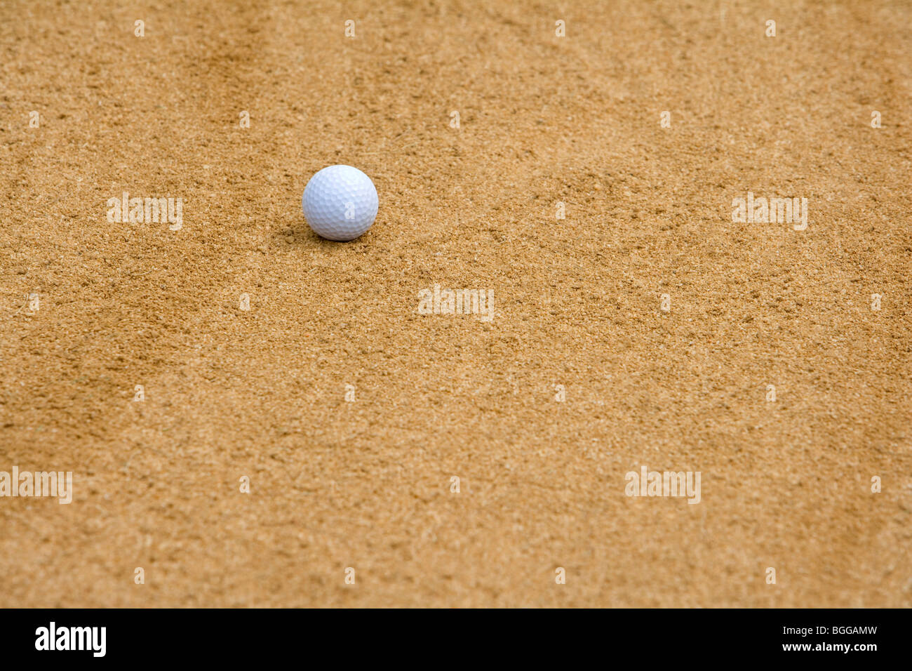 Golf ball in sand bunker Stock Photo - Alamy