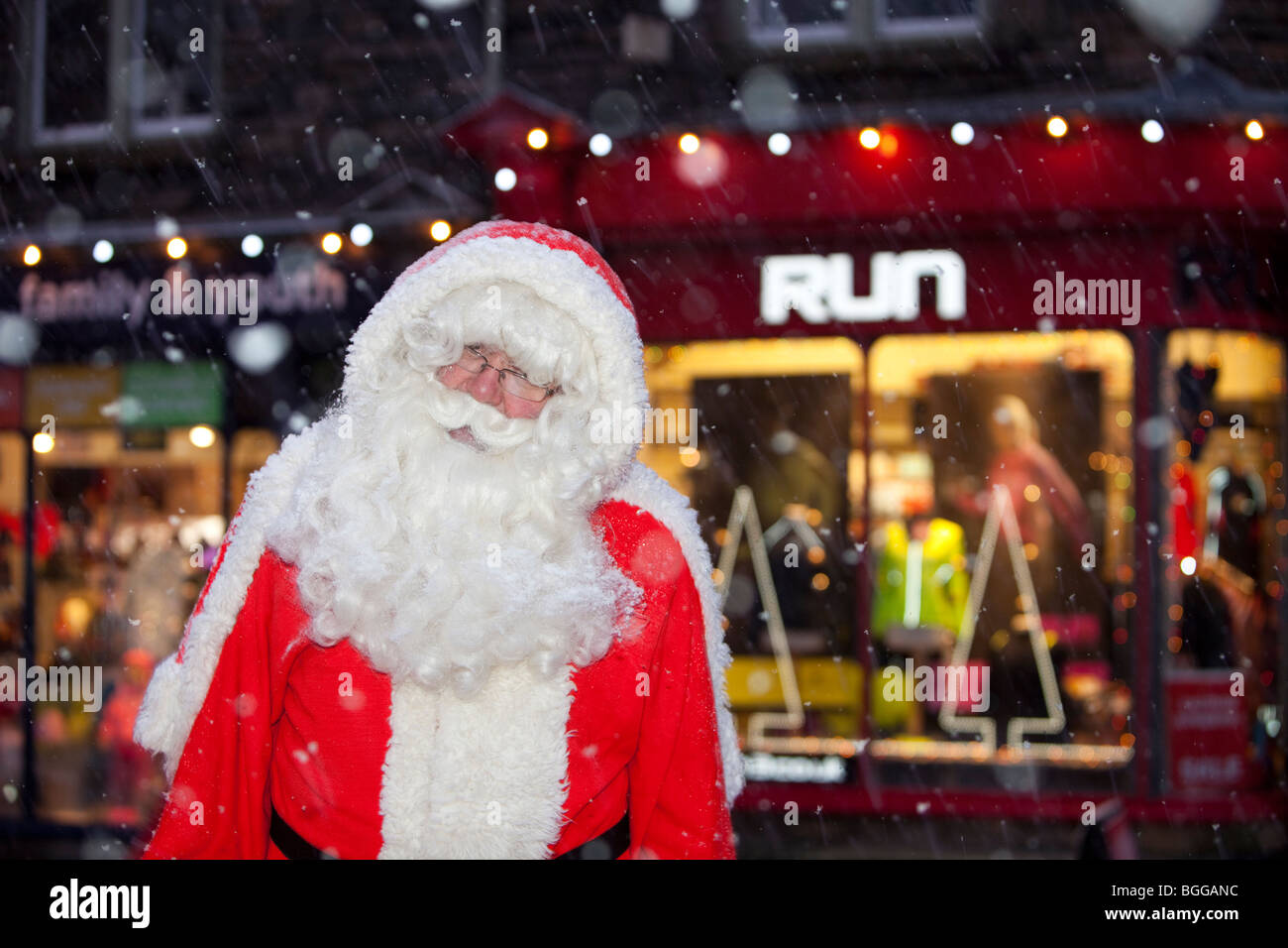 Father Christmas in snow in Ambleside, Cumbria, UK Stock Photo - Alamy
