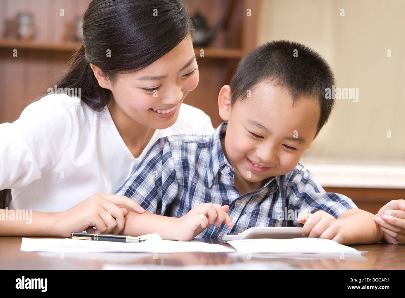 Mother and son doing calculation Stock Photo - Alamy