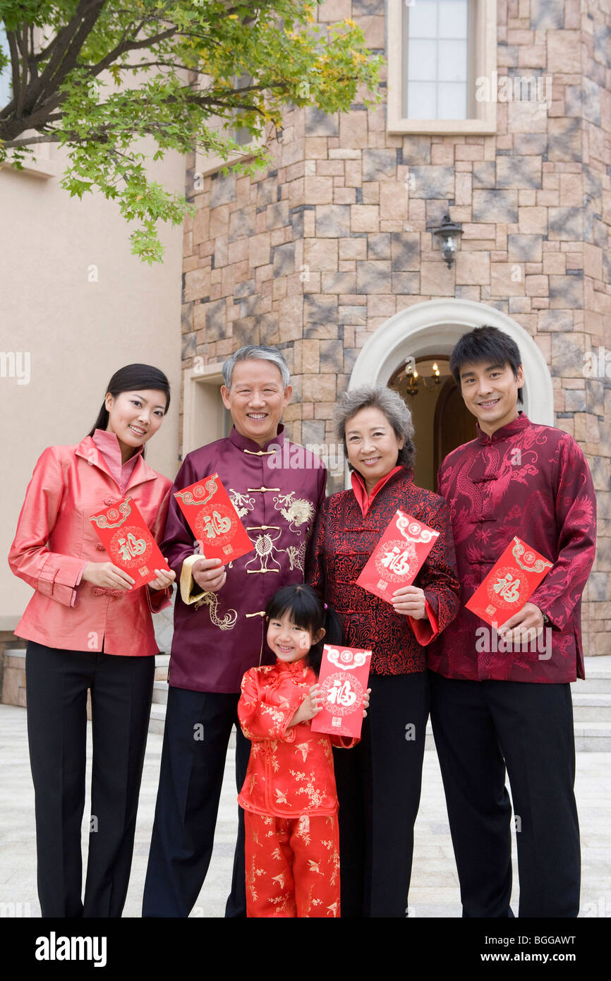 Three generation family holding Chinese new year red envelop Stock ...
