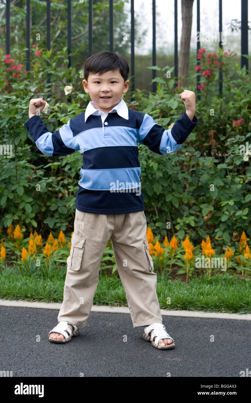 Young boy showing strength Stock Photo - Alamy