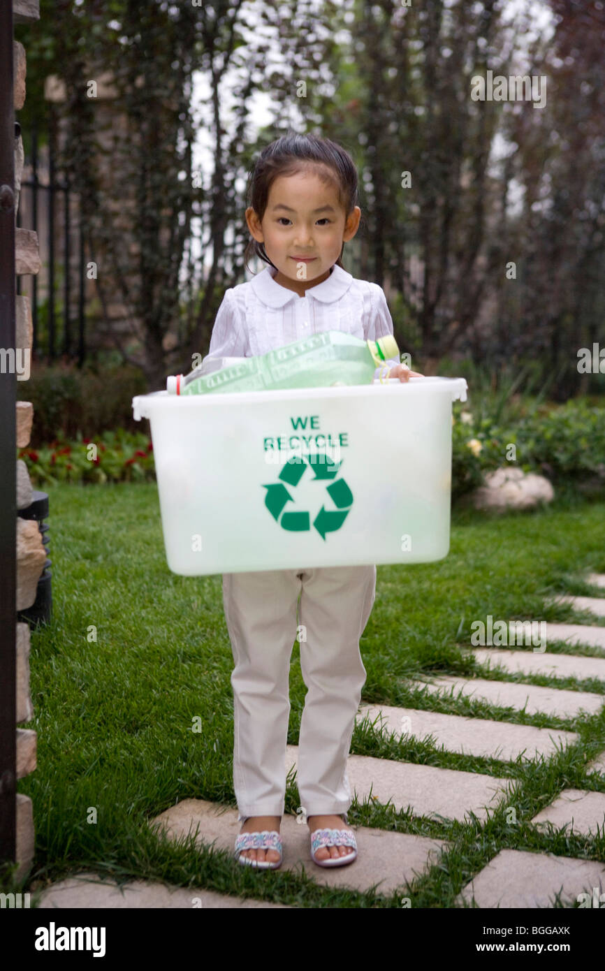 Young girl carrying recycling box Stock Photo - Alamy