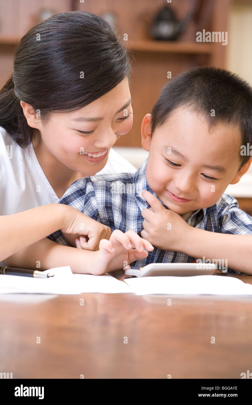 Mother and son doing calculation Stock Photo - Alamy