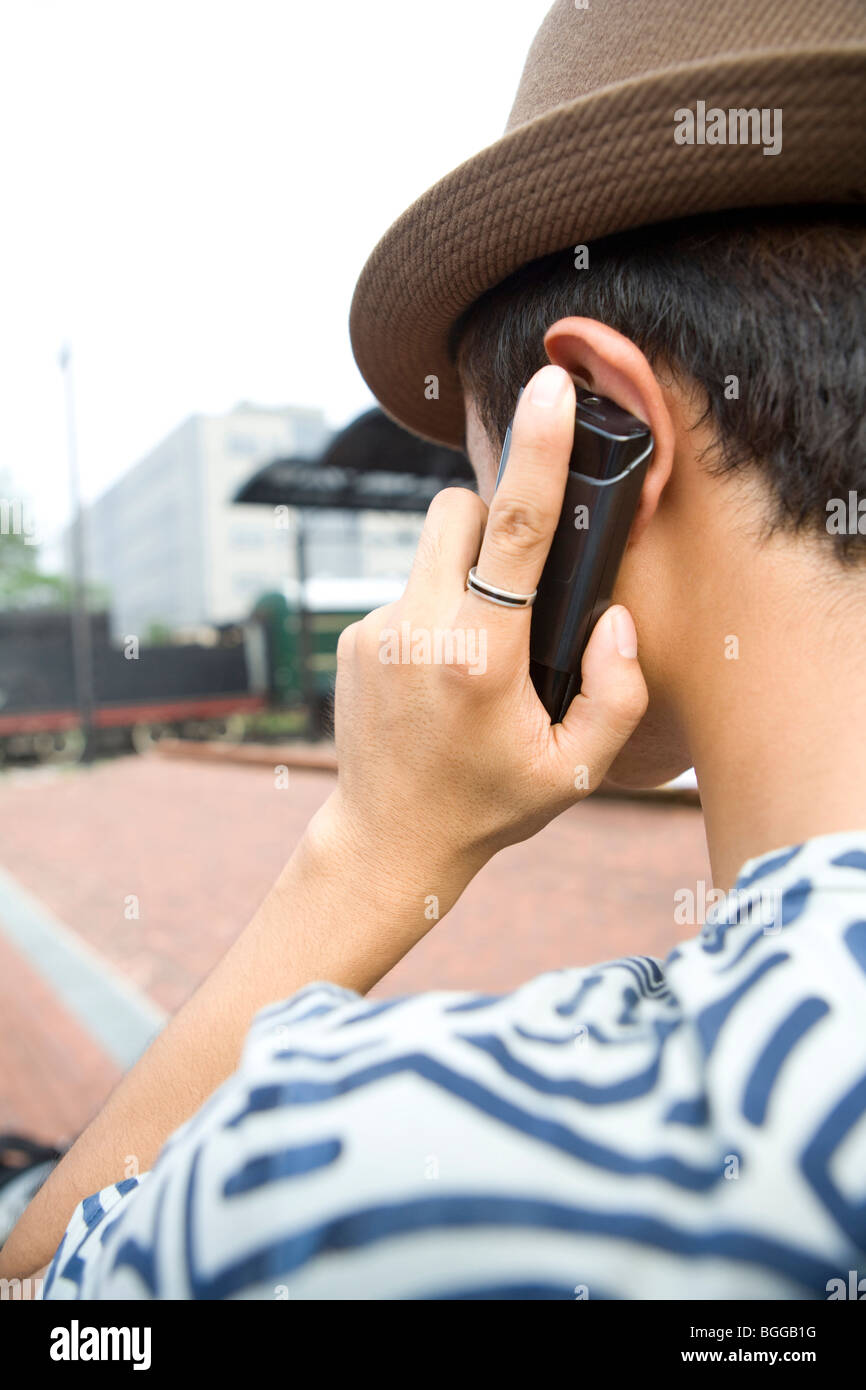 Young man using cell phone Stock Photo - Alamy